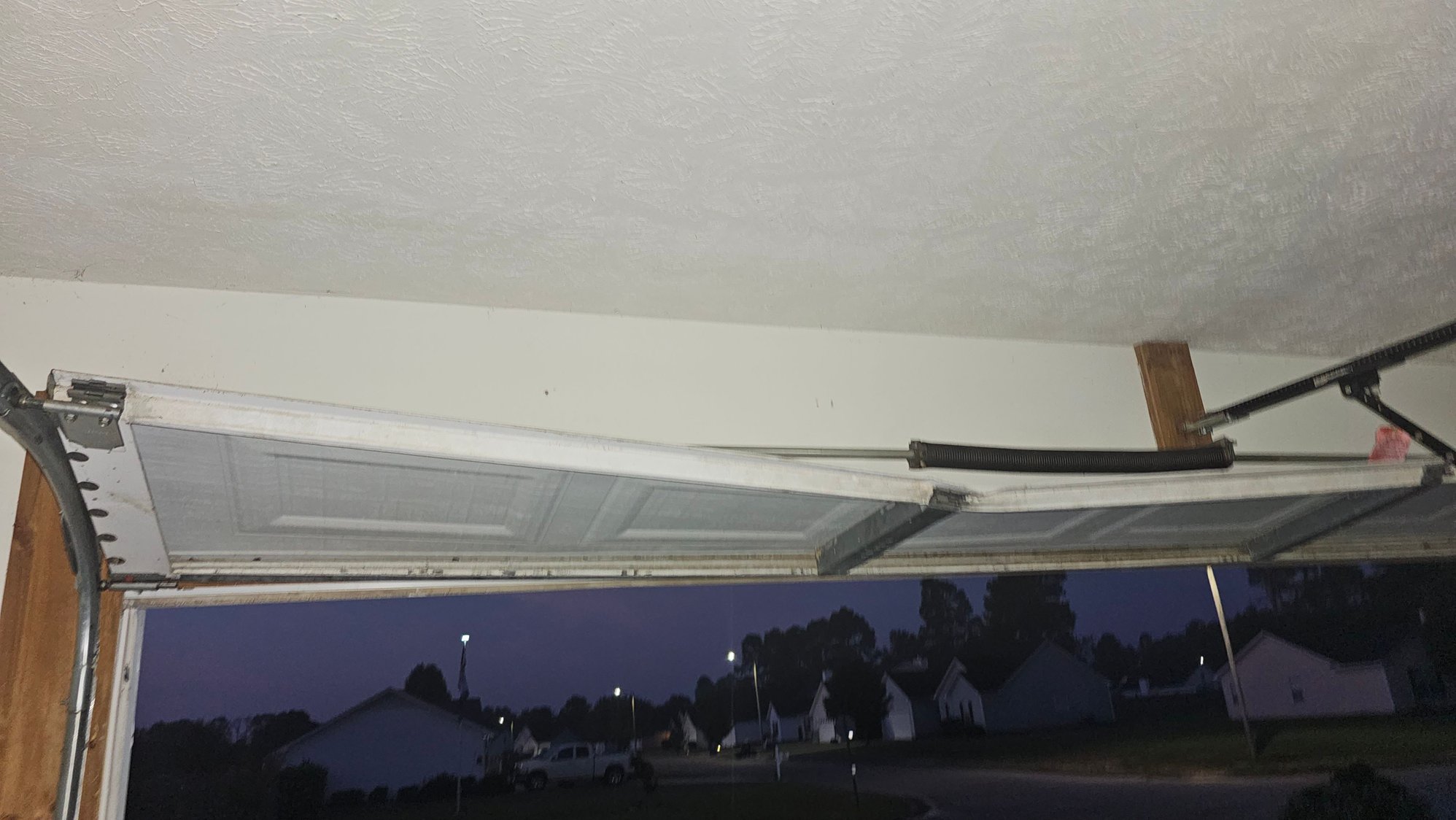 Older type plastic riveted hinge garage door folded on itself ...